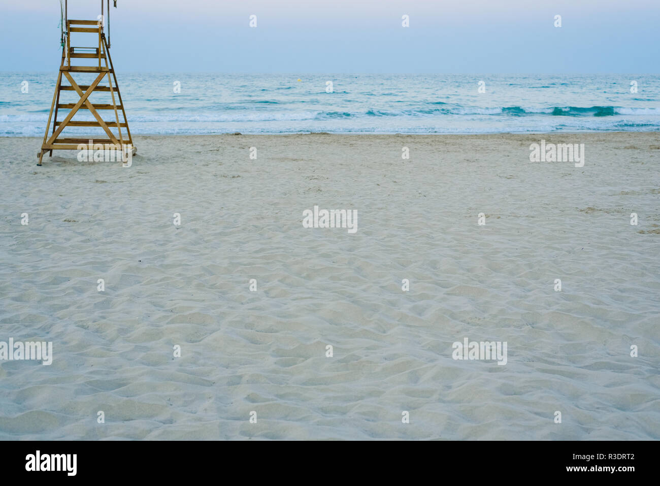 Lifeguard watchtower on the beach at sunset Stock Photo - Alamy