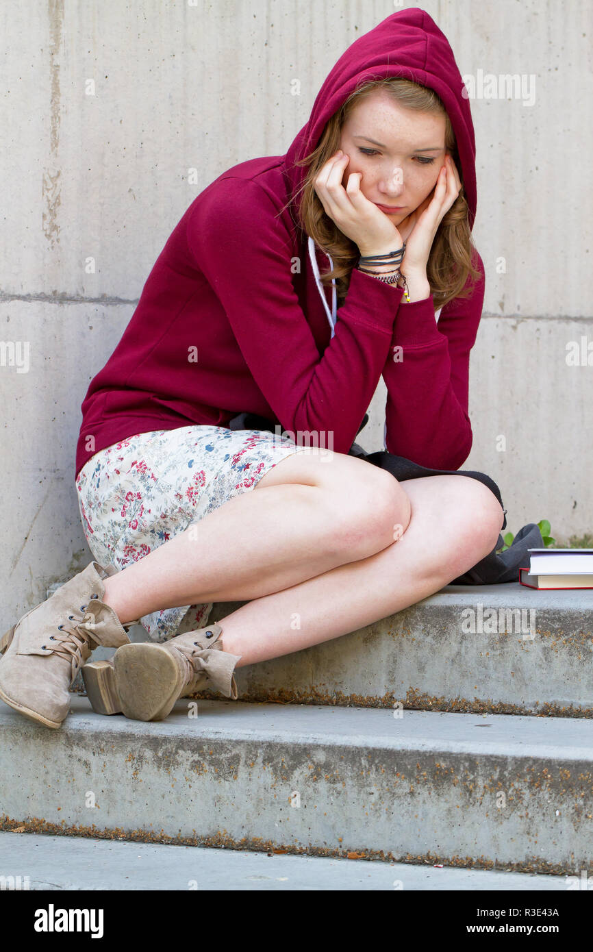 sad student on a staircase Stock Photo - Alamy