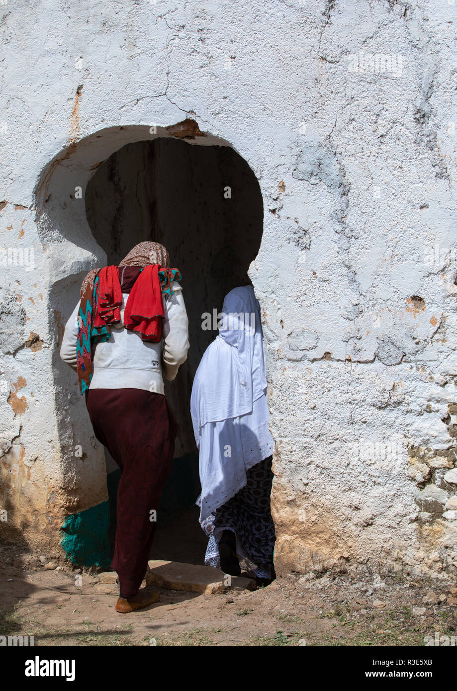 Harari women entering a door in a muslim holy site, Harari Region ...