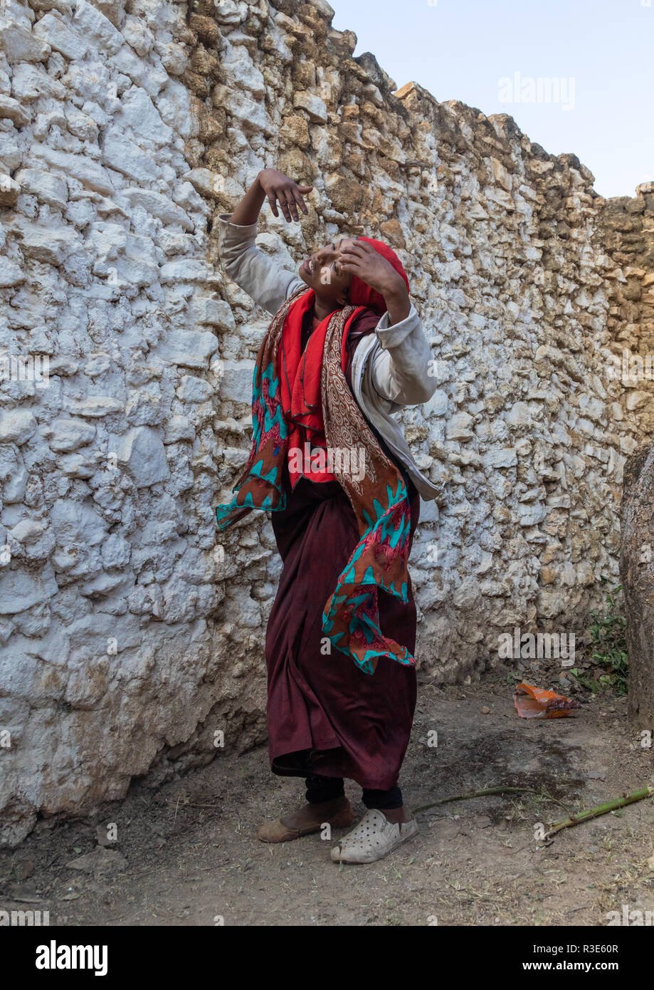 Sufi woman with a red veil into trance during a muslim ceremony, Harari ...