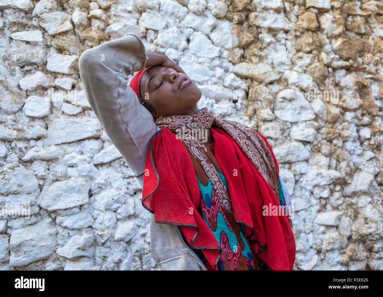 Sufi woman with a red veil into trance during a muslim ceremony, Harari ...