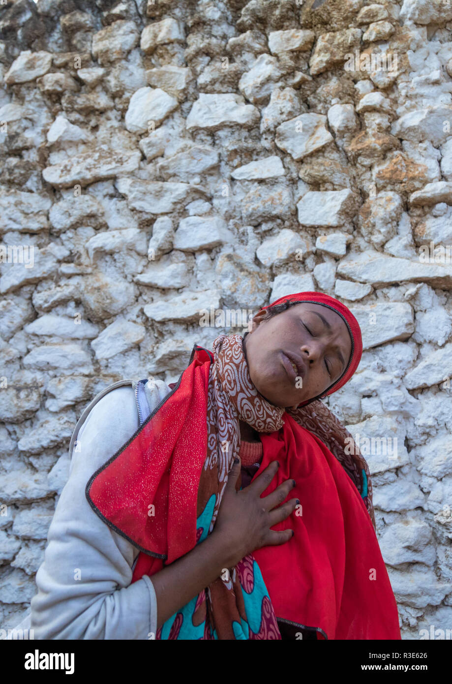 Sufi woman with a red veil into trance during a muslim ceremony, Harari ...