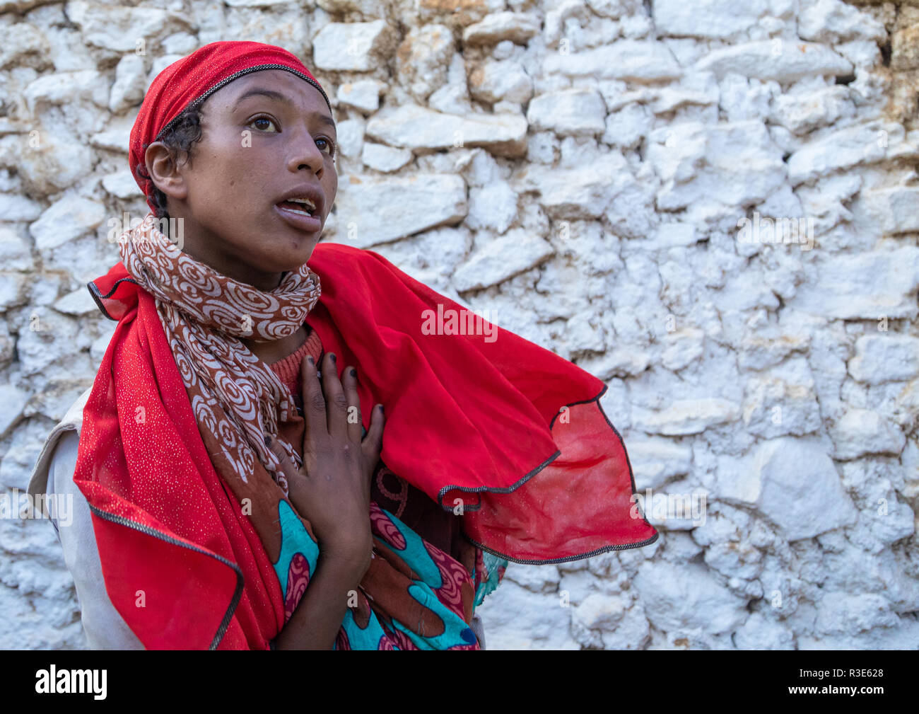 Sufi woman with a red veil into trance during a muslim ceremony, Harari ...