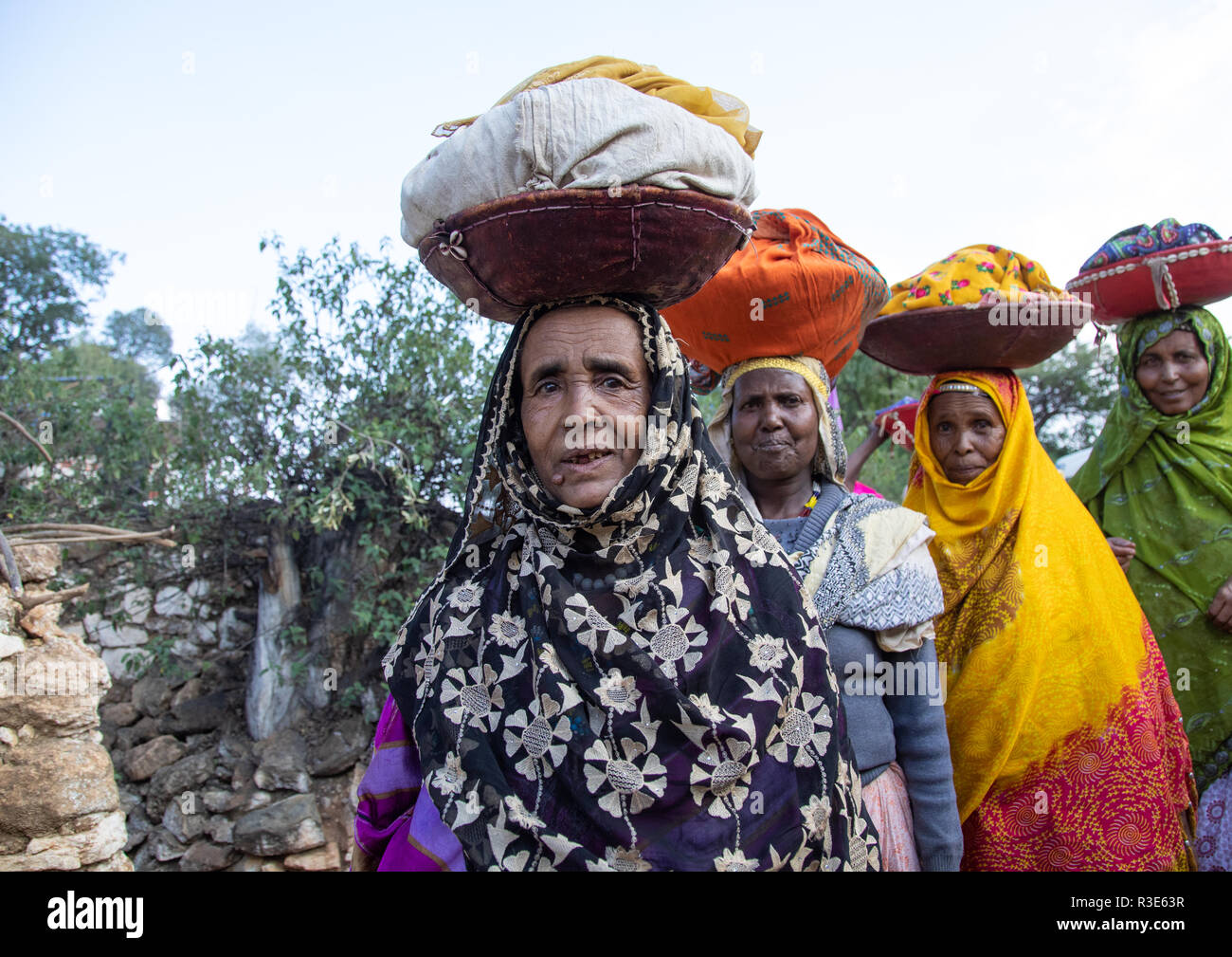 Harari women bringing injeras in baskets on their heads for a muslim ...