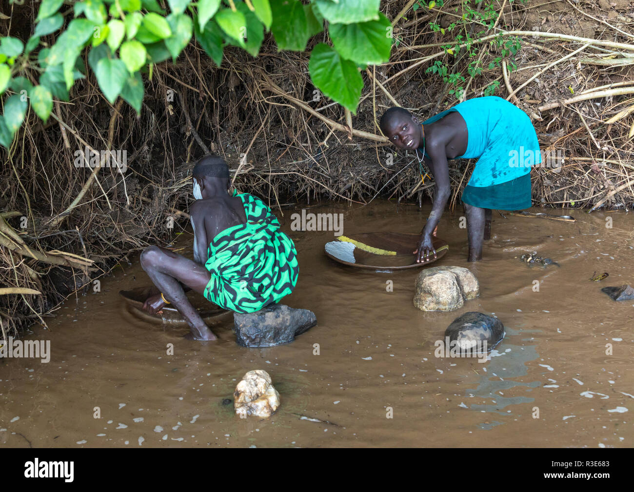 Suri tribe girls doing gold panning in a river, Omo valley, Kibish ...