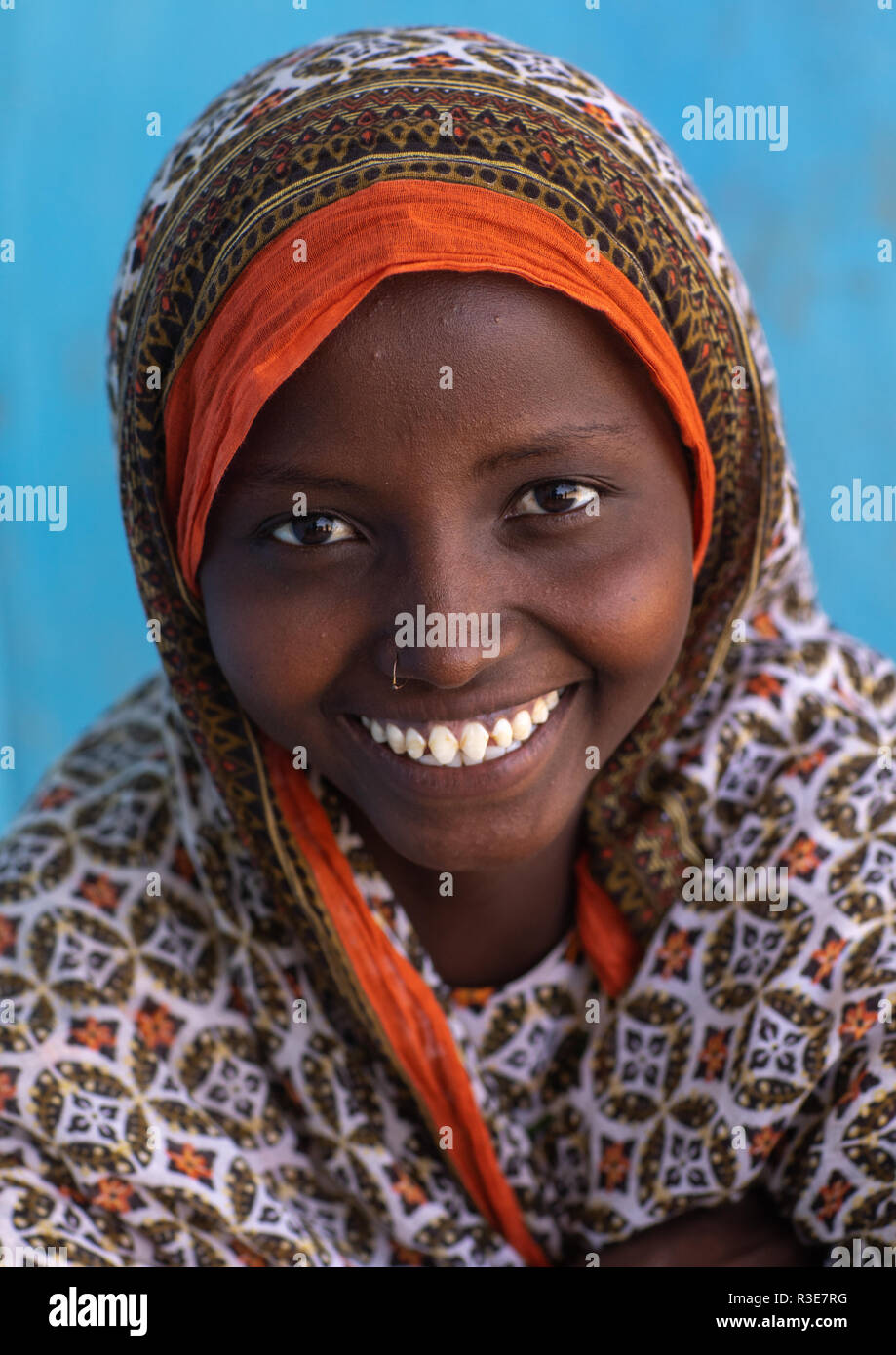 Portrait of a veiled smiling afar tribe girl with sharpened teeth, Afar ...