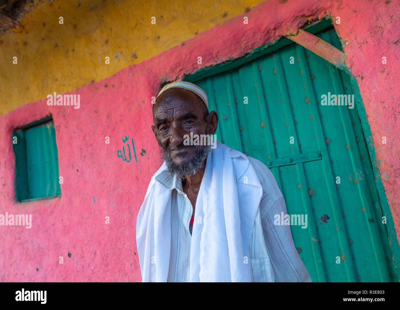 Portrait of an old afar tribe man in front of a pink house, Afar Region ...