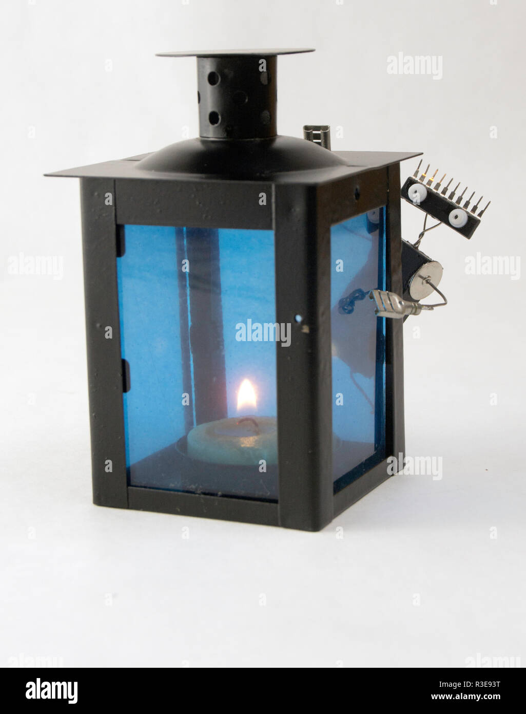 Robot peeking around burning lantern Stock Photo - Alamy
