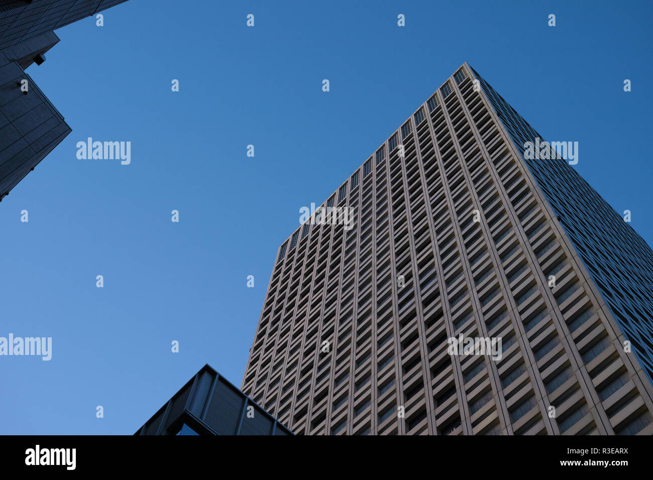 A modern tower block, full of offices or apartments, towering into an ...
