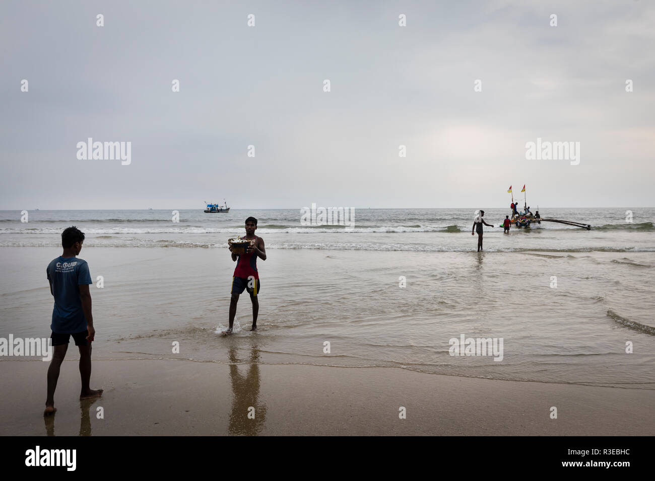 Fishermen bring back fish from their boats on the popular beach state ...