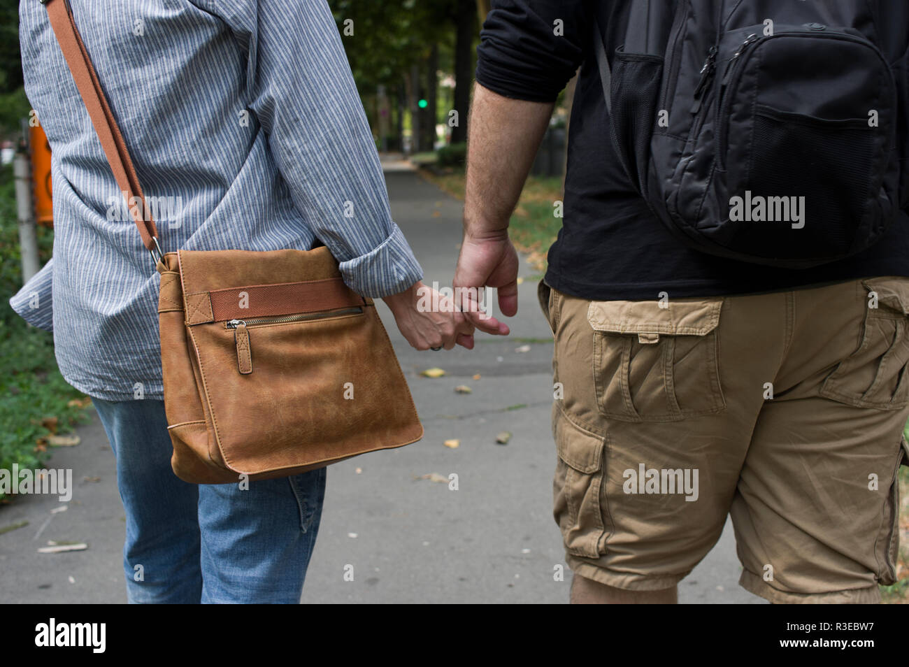 Couple holding hands outside in Berlin, Germany Stock Photo - Alamy