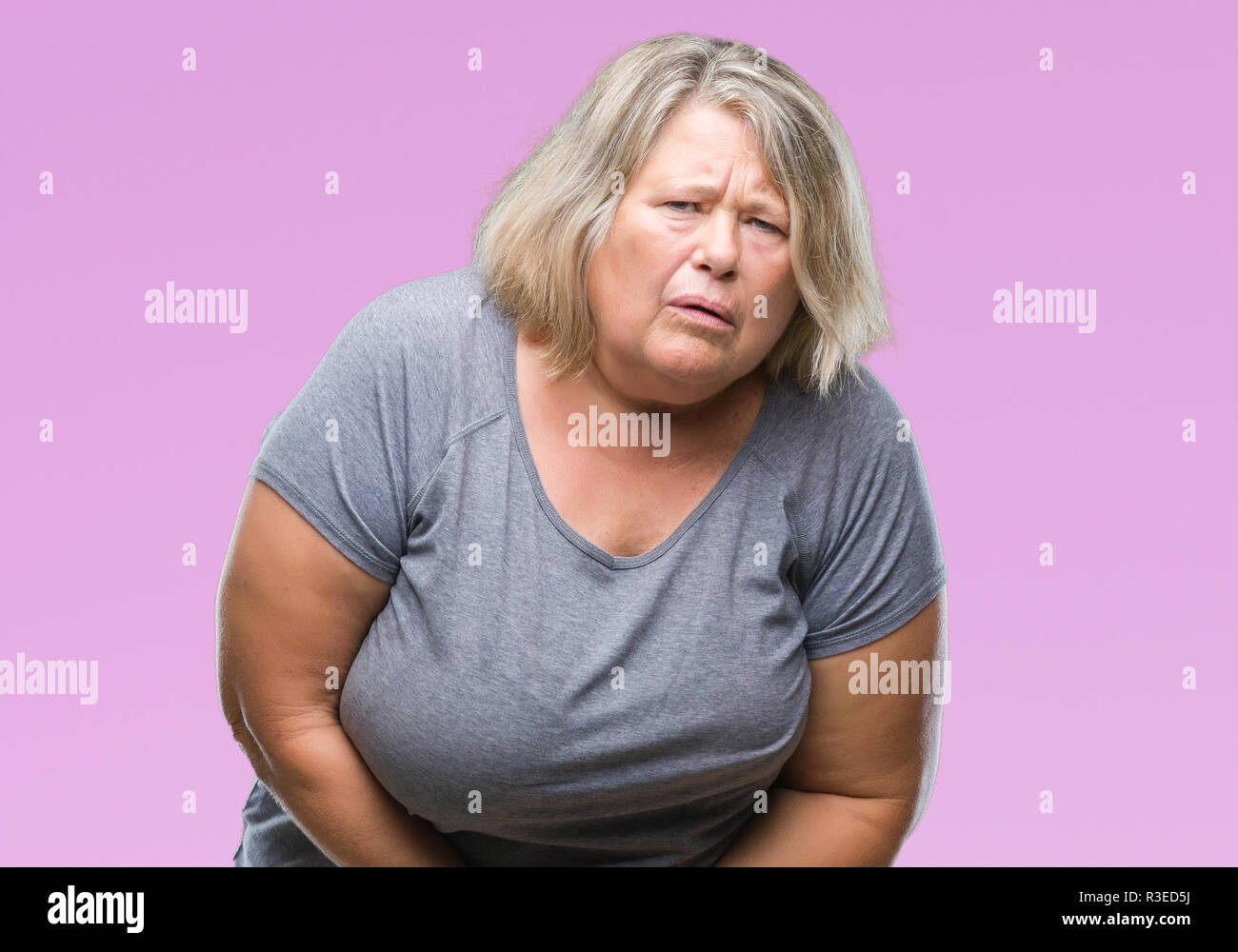 Senior plus size caucasian woman over isolated background with hand on ...
