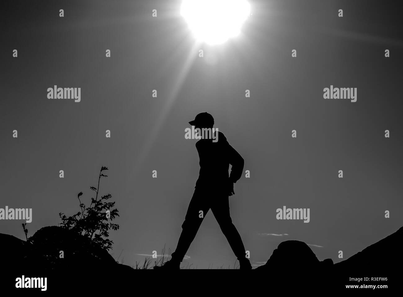 Male silhouette walking in natural backlight with the harsh sun right ...