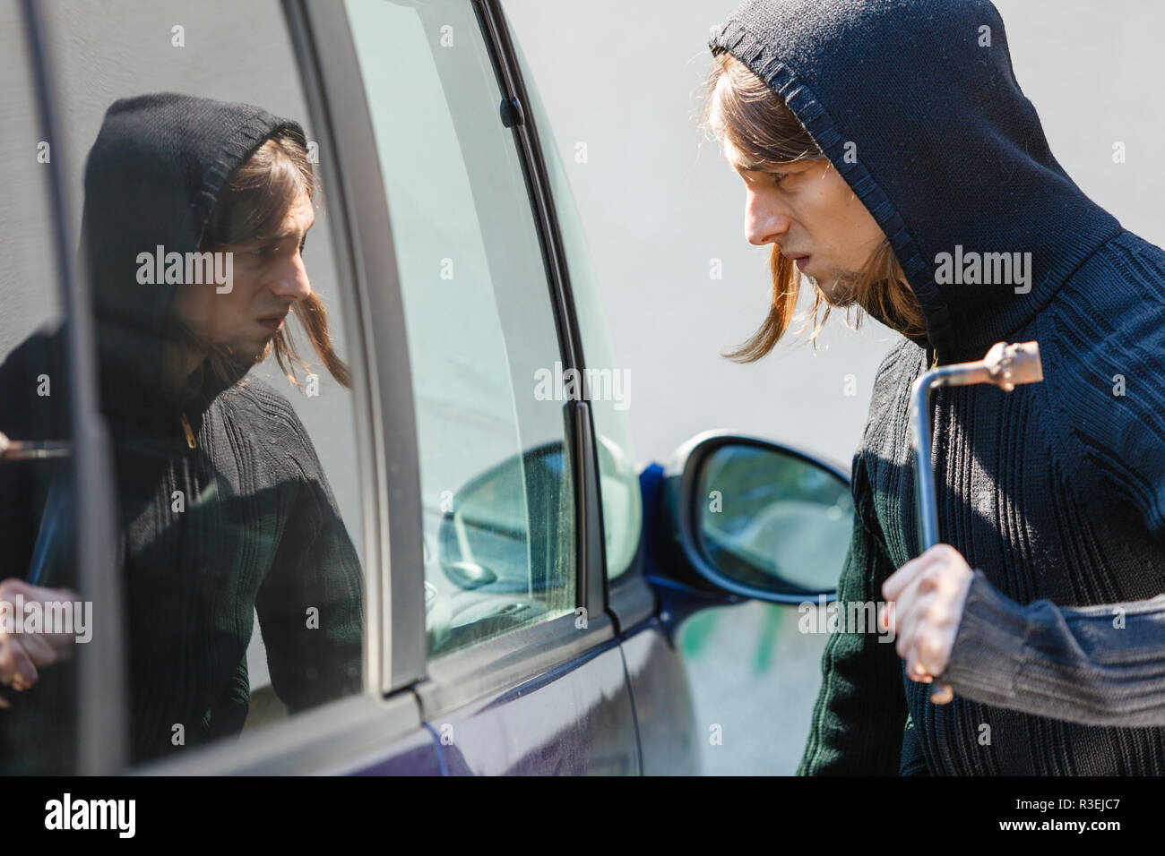 Transportation, crime and ownership concept - Male hooded thief burglar ...