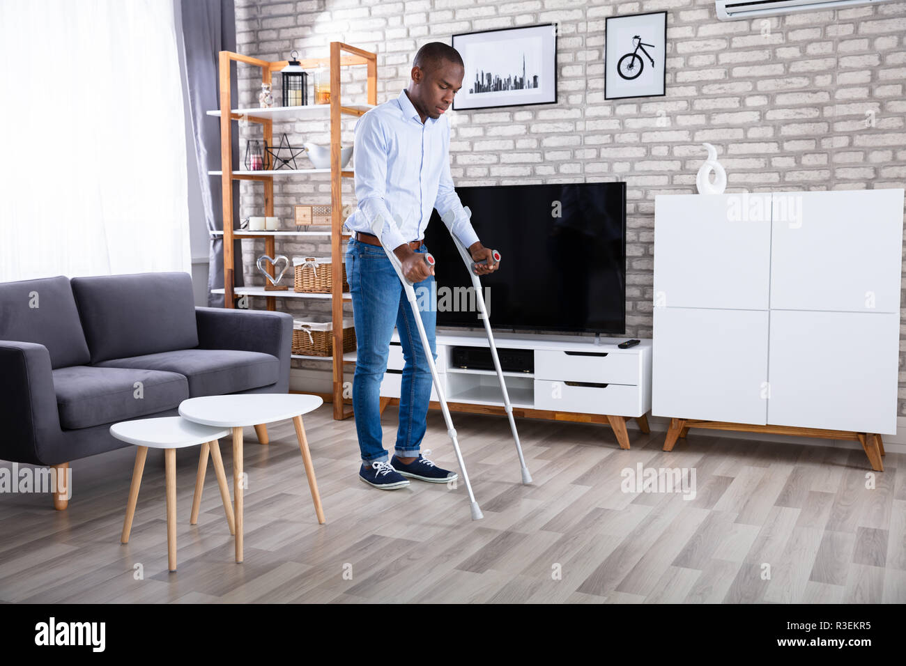 Disabled Man Using Crutches For Walking On Floor Stock Photo - Alamy