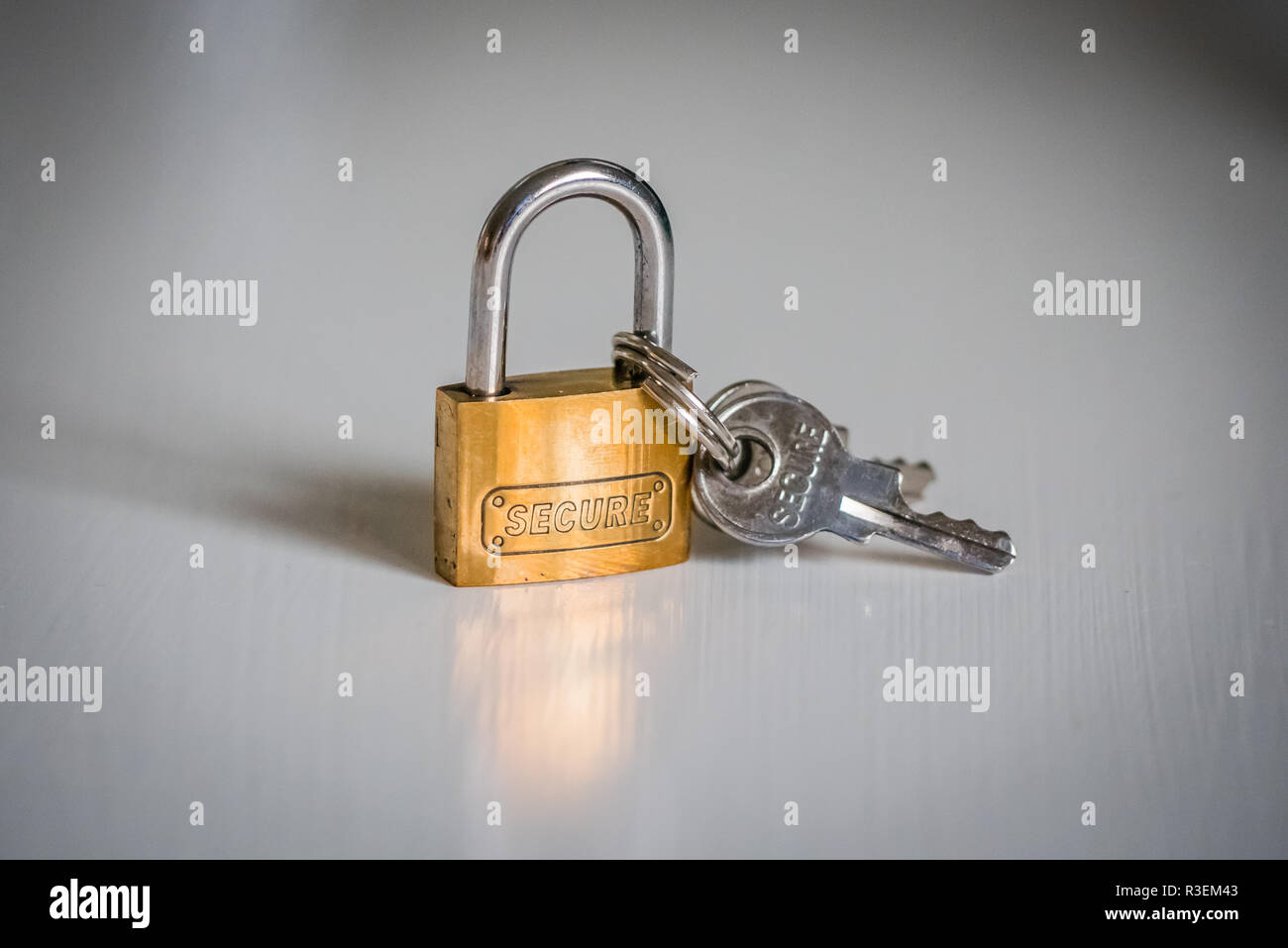 small gold metal lock with keys Stock Photo - Alamy