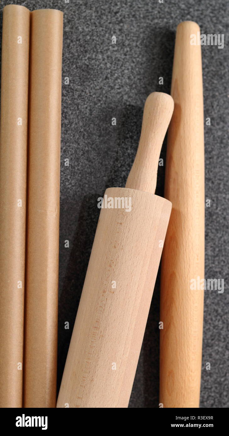 Rolling pins and baking parchment on granite table. Directly Above ...