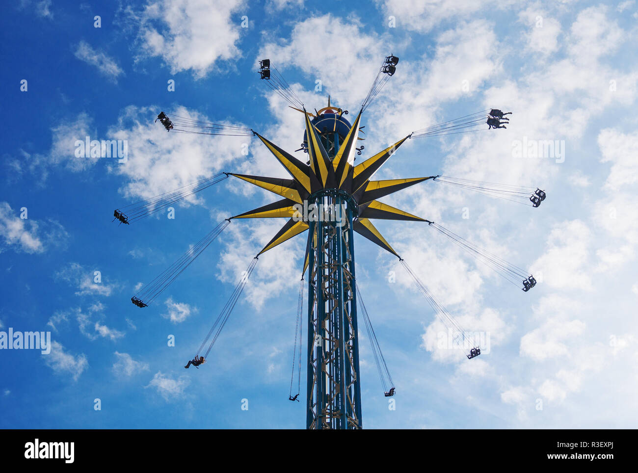 Flying swinging high chained carousel in amusement park Stock Photo - Alamy