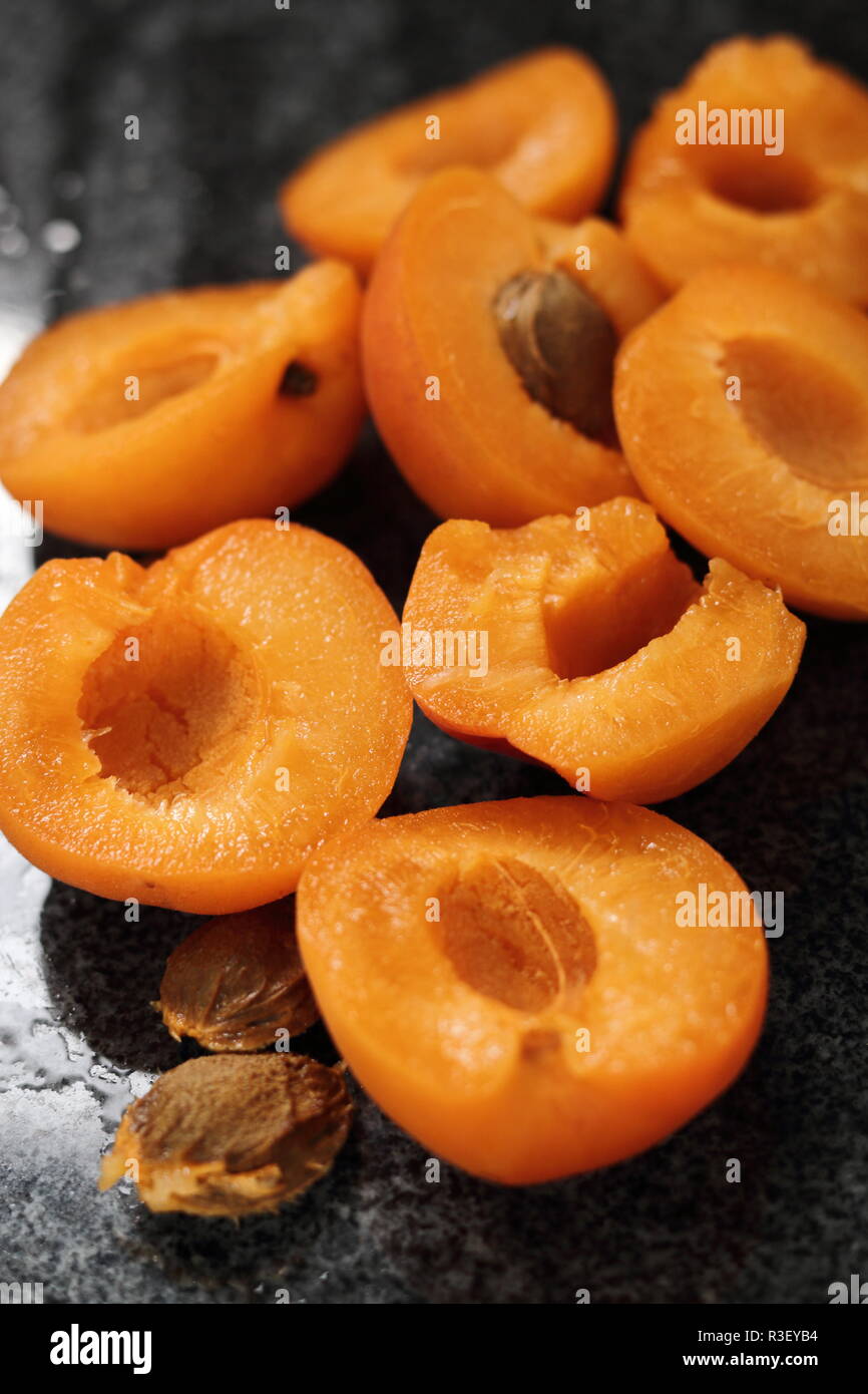 Fresh apricot halves on granite table Stock Photo - Alamy