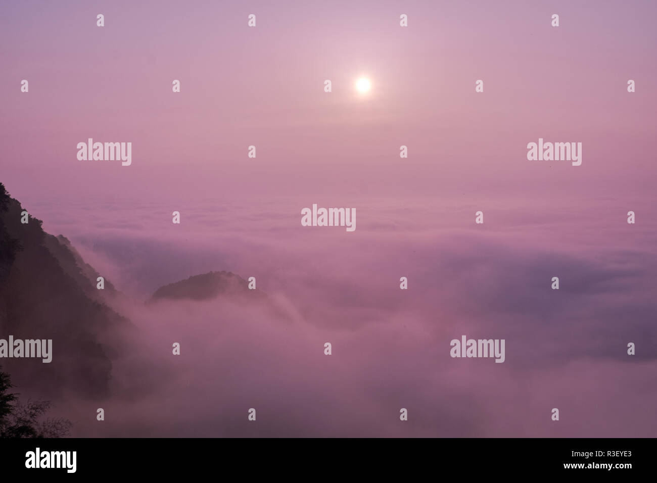 Purple sunrise in clouds in mountain on top of mountain Stock Photo - Alamy
