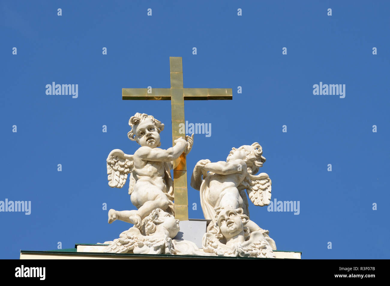 Two angels with a cross, against the blue sky Stock Photo - Alamy