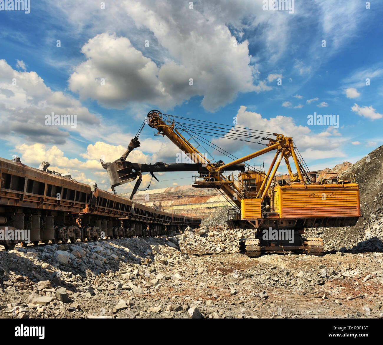 Loading of iron ore on the train in career Stock Photo - Alamy