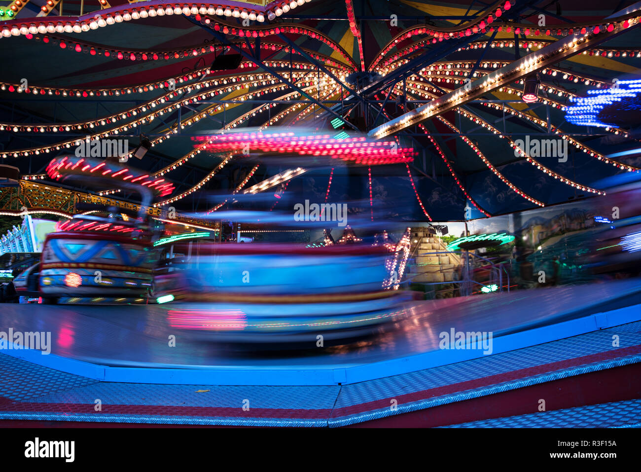 fast funfair ride carousel at the christmas market, long exposure with ...