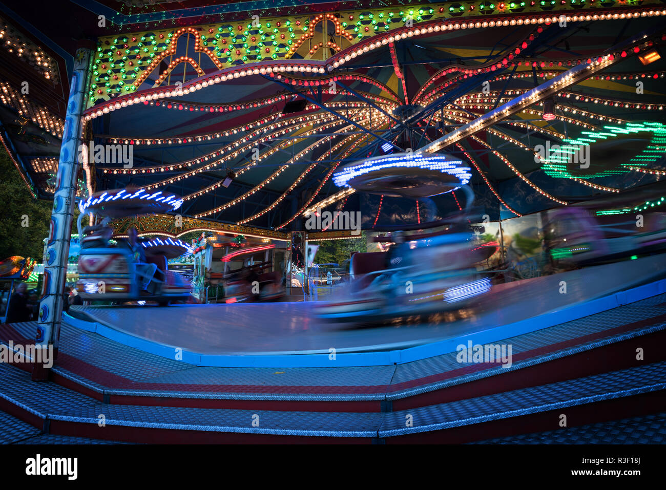 fast funfair ride carousel at the christmas market, long exposure with ...