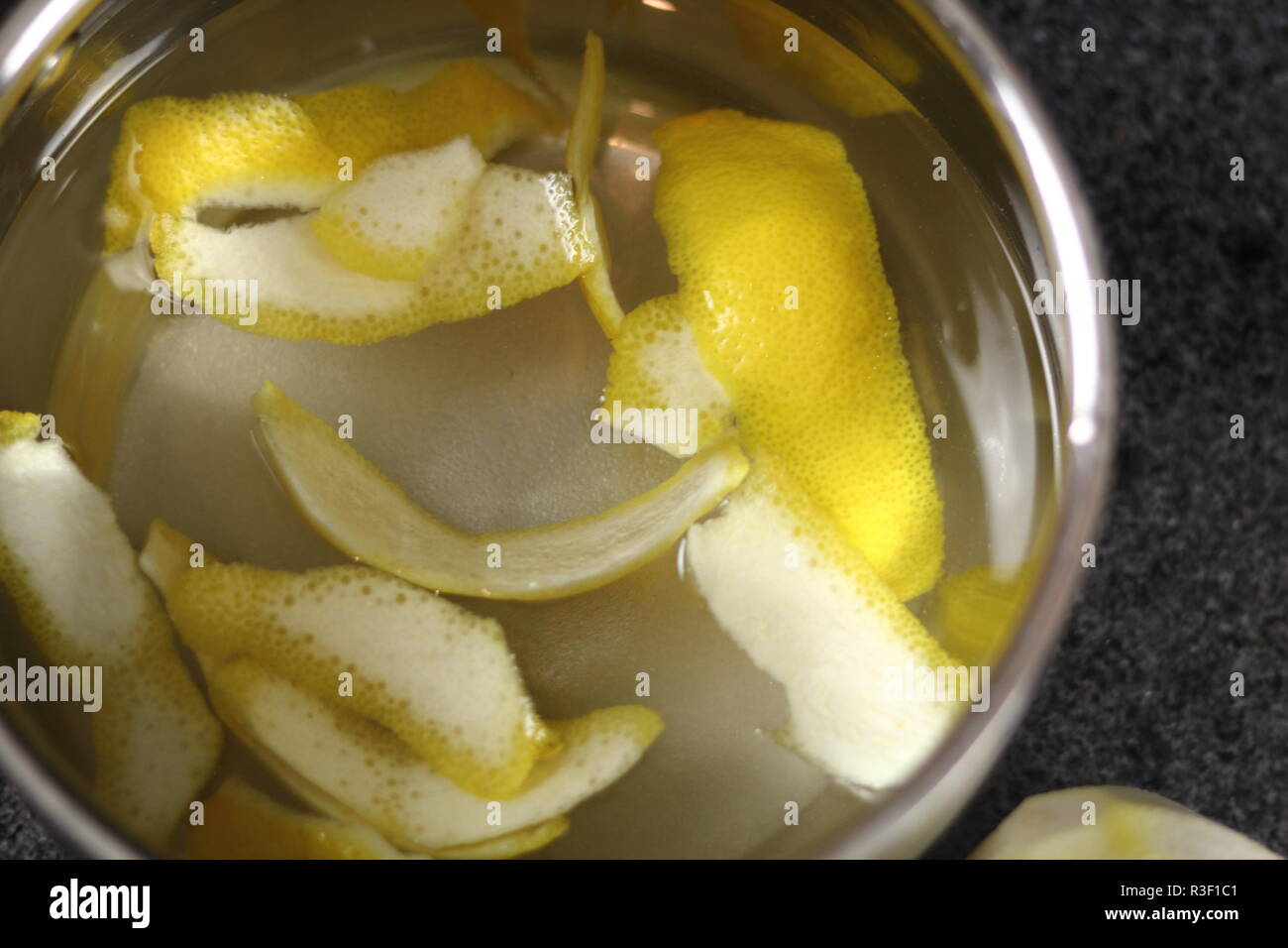 Lemon skin in pan with water. Directly above Stock Photo - Alamy