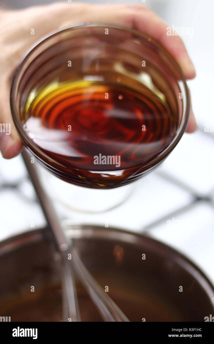 Pouring treacle syrup into chocolate mixture Stock Photo - Alamy