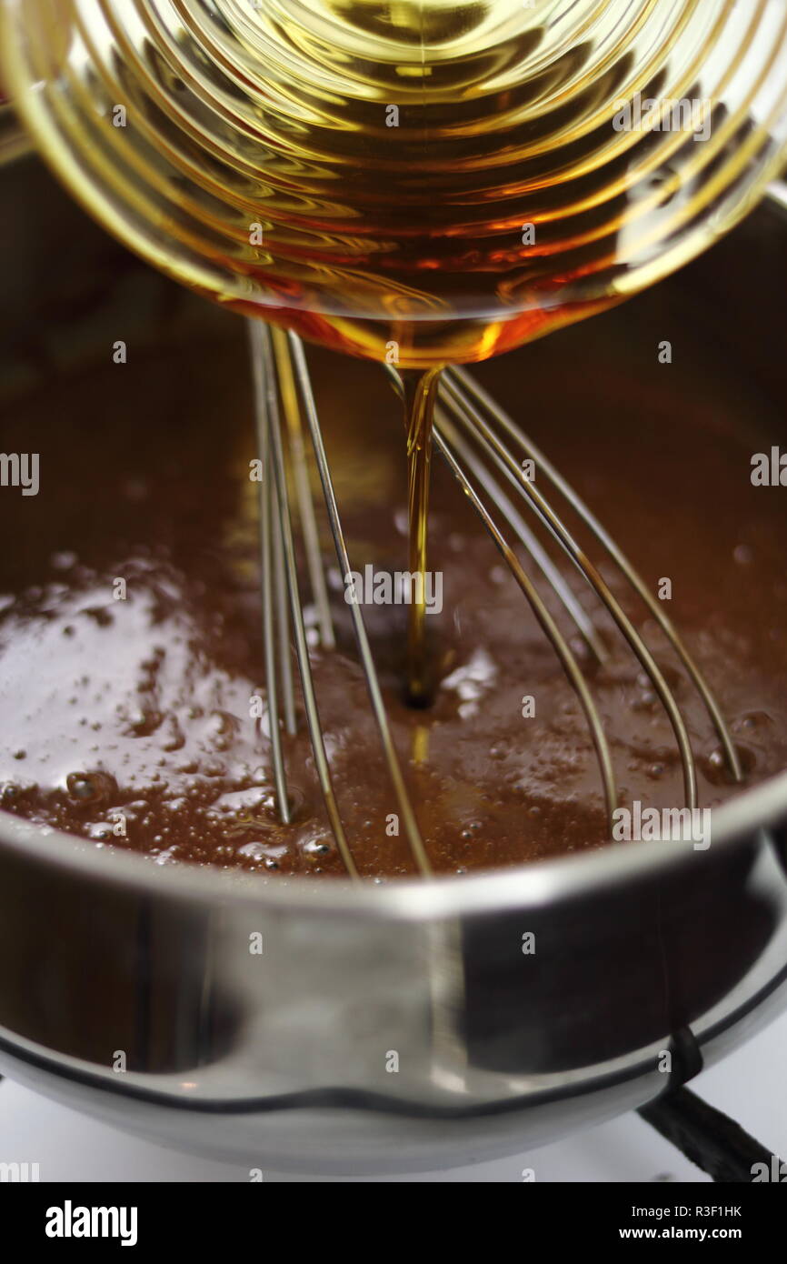 Pouring treacle syrup into chocolate mixture Stock Photo - Alamy