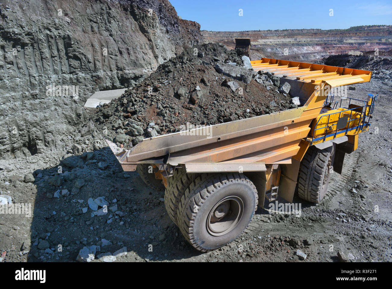 Large quarry dump truck. Loading the rock in the dumper. Loading coal ...