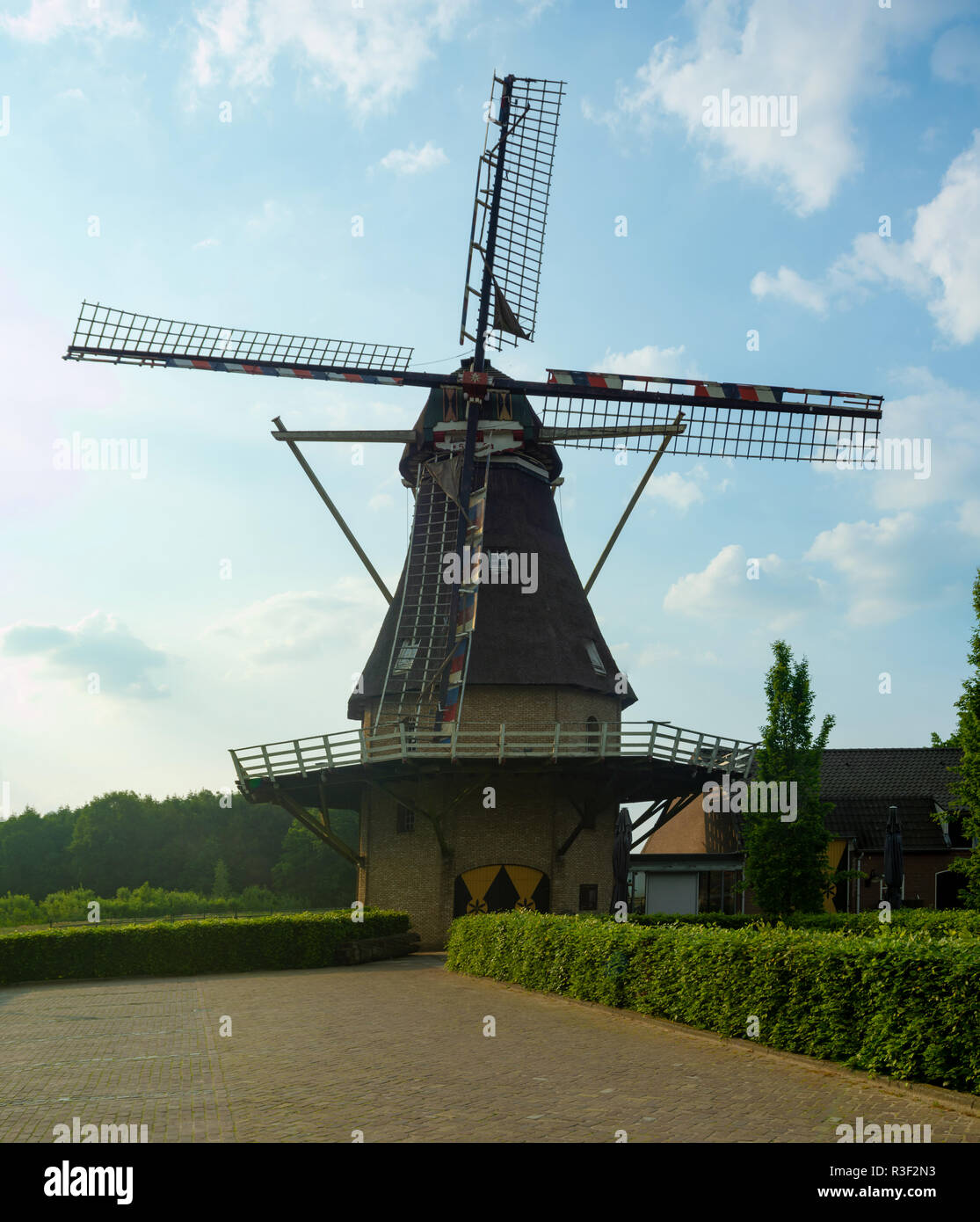 Traditional old Dutch grain wind mill, Dutch countryside landscape ...