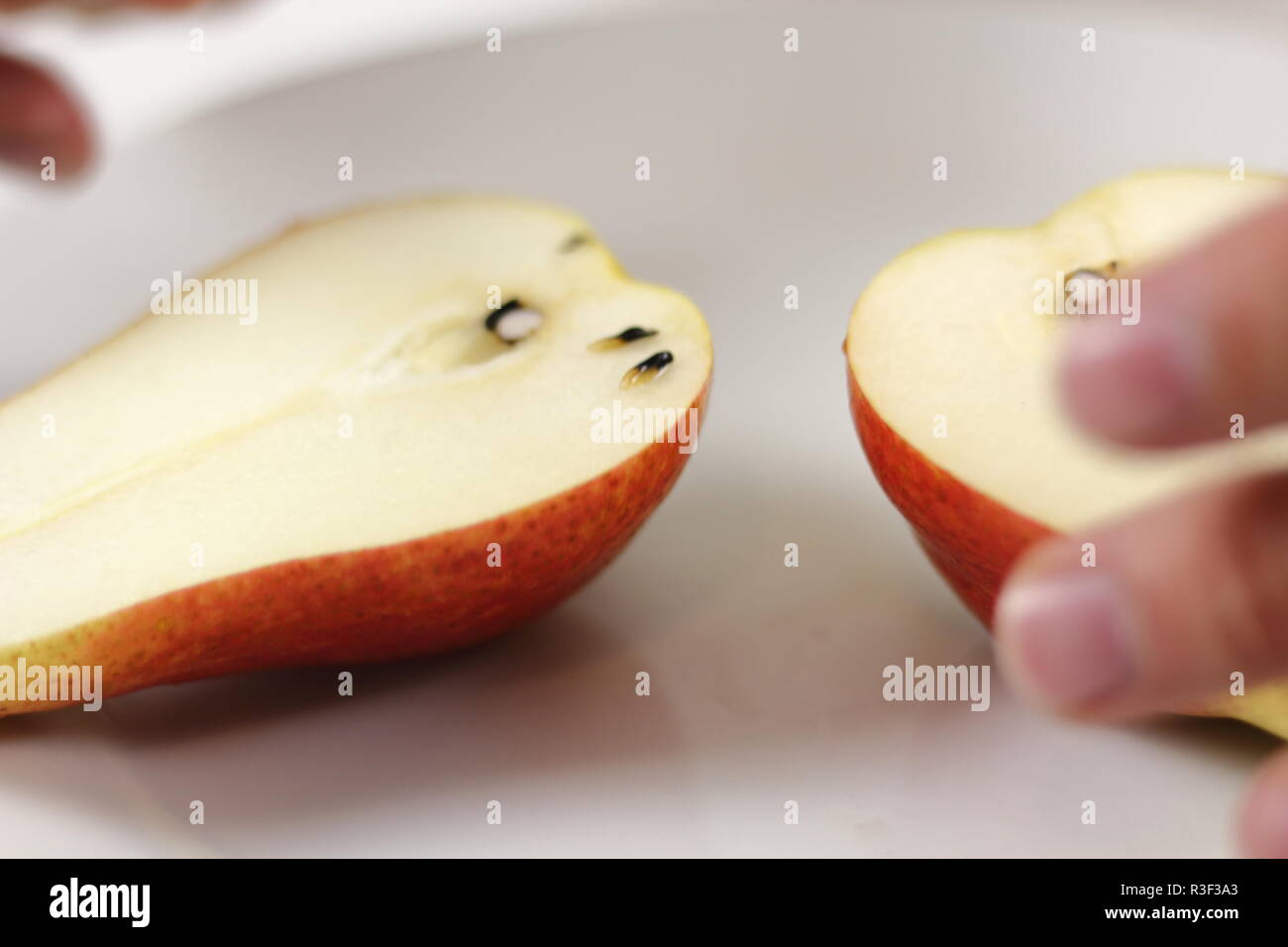 Removing core of pear Stock Photo - Alamy