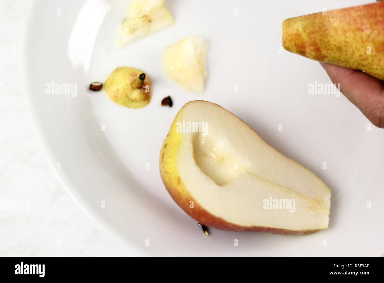 Removing core of pear Stock Photo - Alamy
