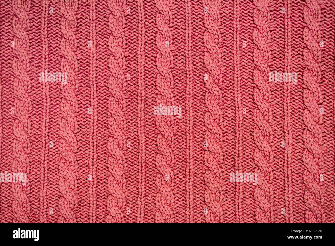 Red knitted fabric with a pattern a braid texture knitwear Stock Photo ...
