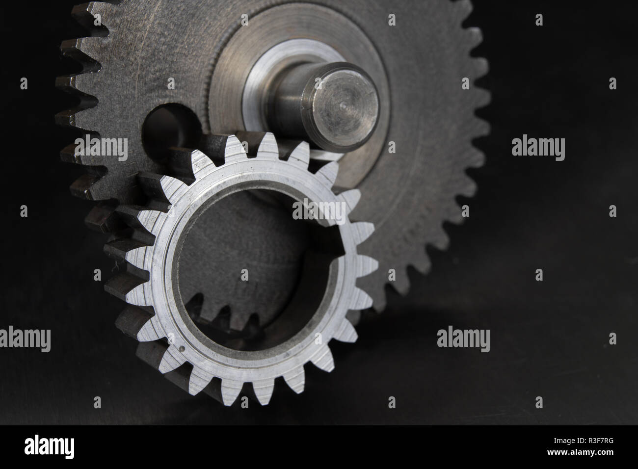 Gears on a metal workshop table. Spare parts for industrial machines ...