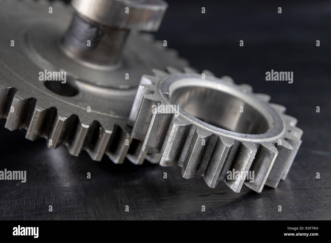 Gears on a metal workshop table. Spare parts for industrial machines ...