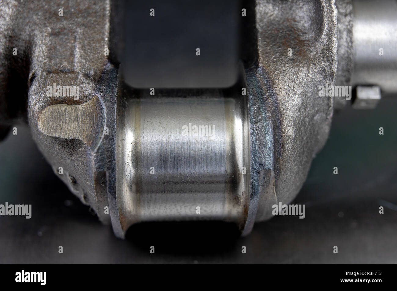 Crankshaft of a four-stroke diesel engine on a metal table. Spare parts ...