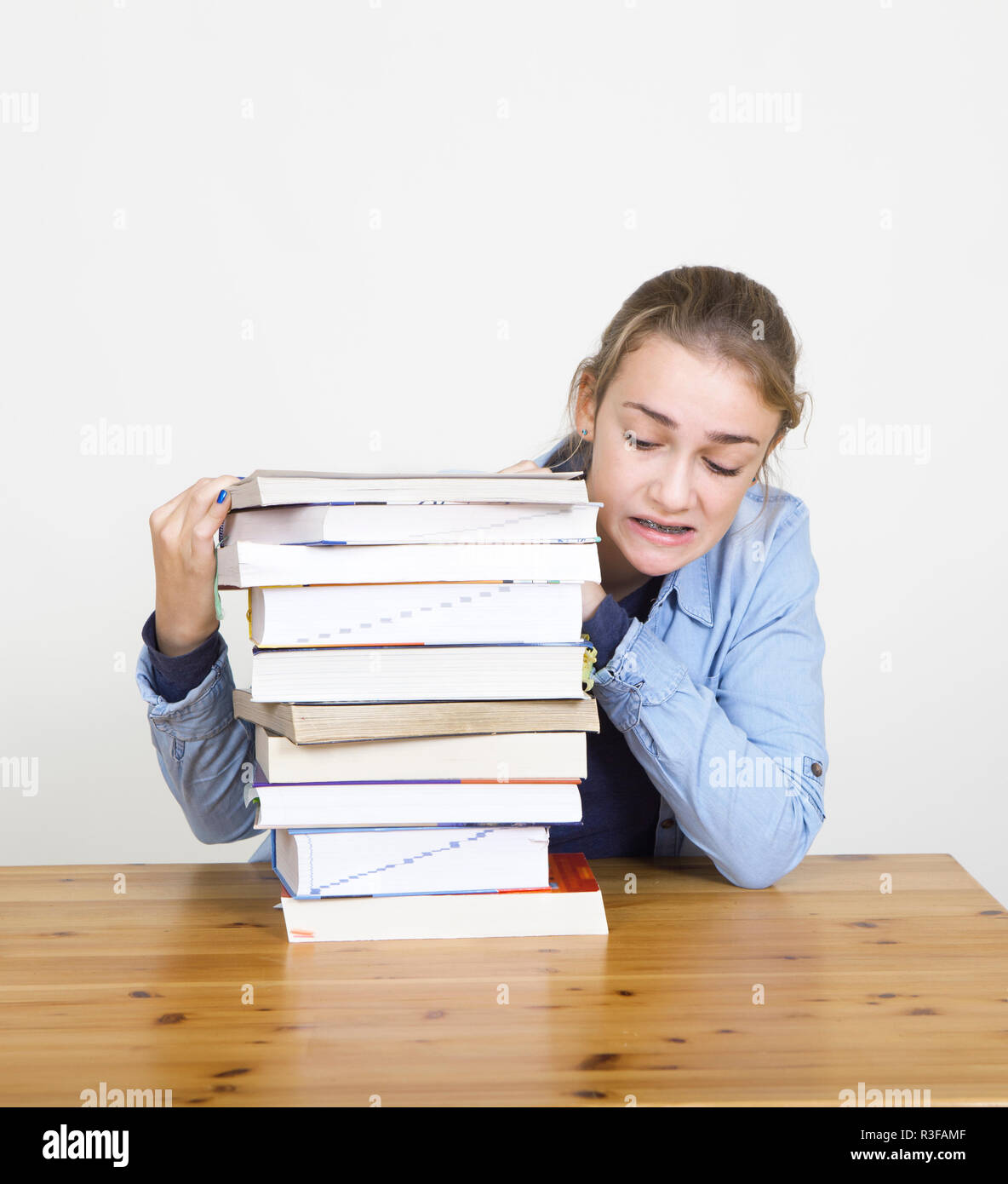 student with many books Stock Photo - Alamy