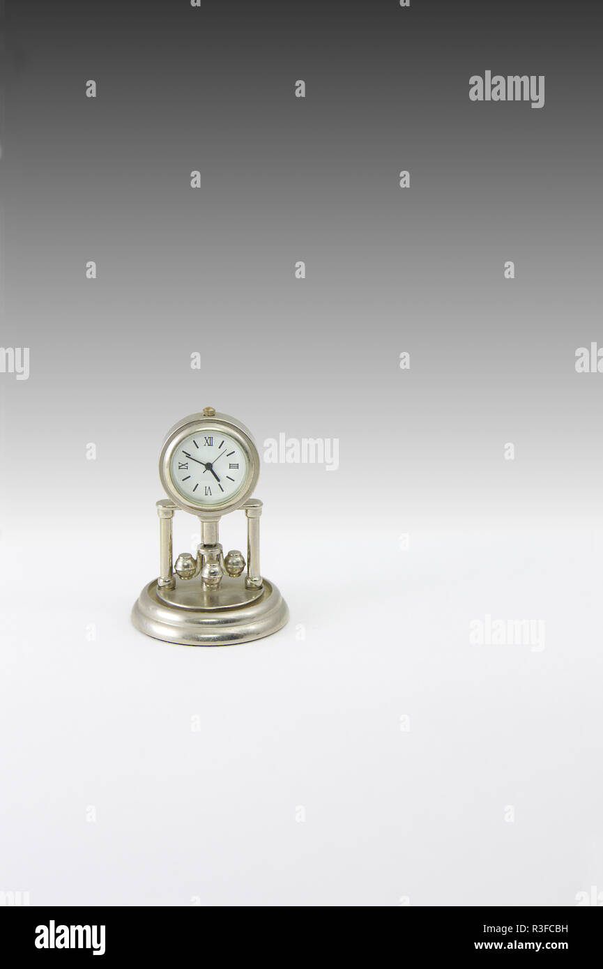 Miniature clock in which the hands mark the four forty-nine with a ...