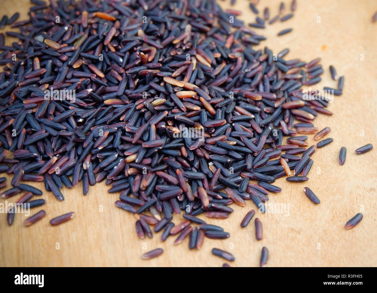 Riceberry organic food / pile of raw riceberries on wood background ...