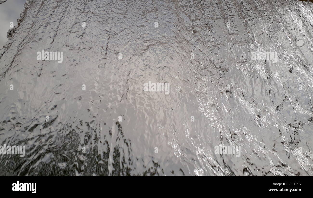 Wide stream of water falling in a semi-translucent park Stock Photo - Alamy