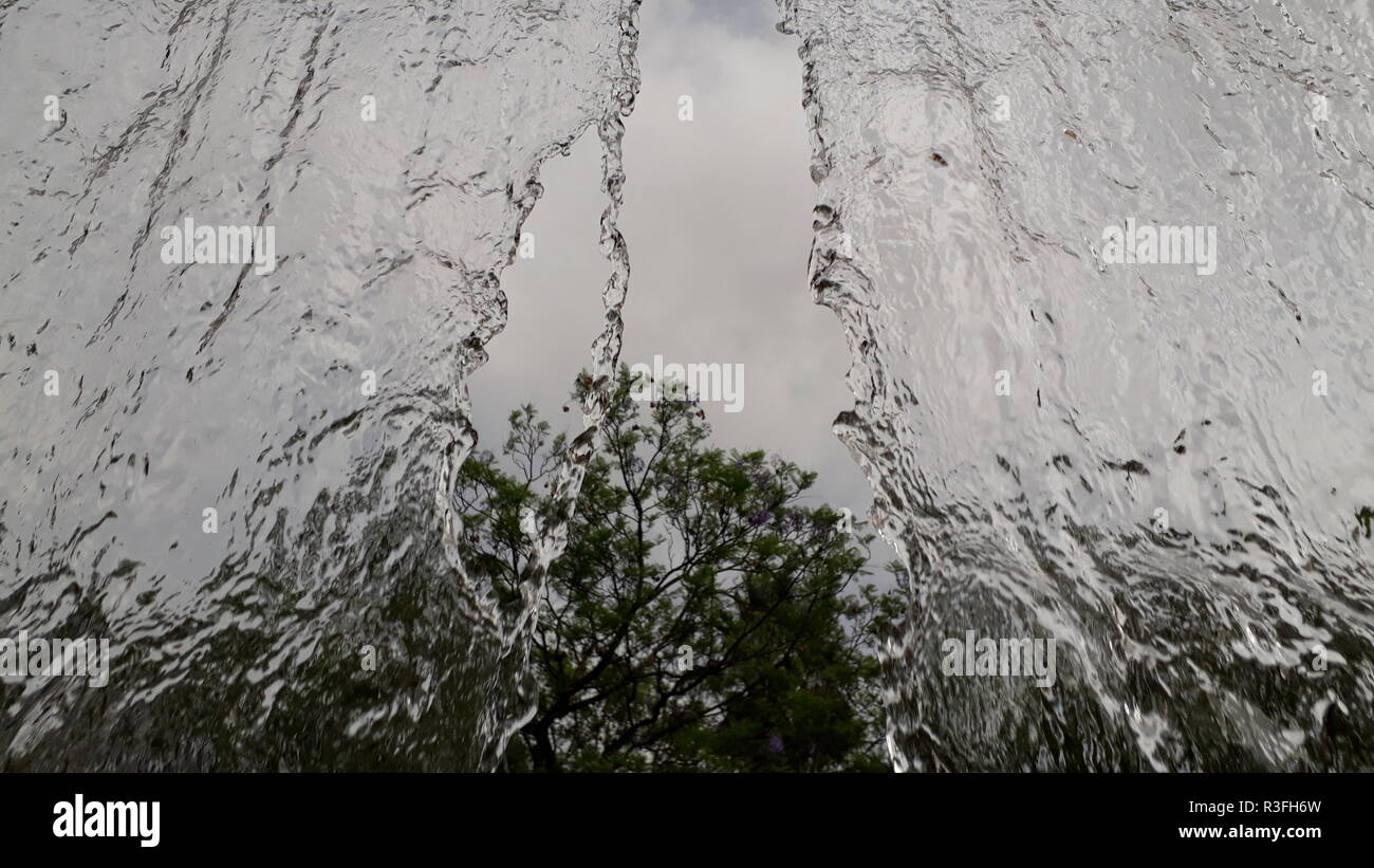 Wide stream of water falling in a semi-translucent park Stock Photo - Alamy