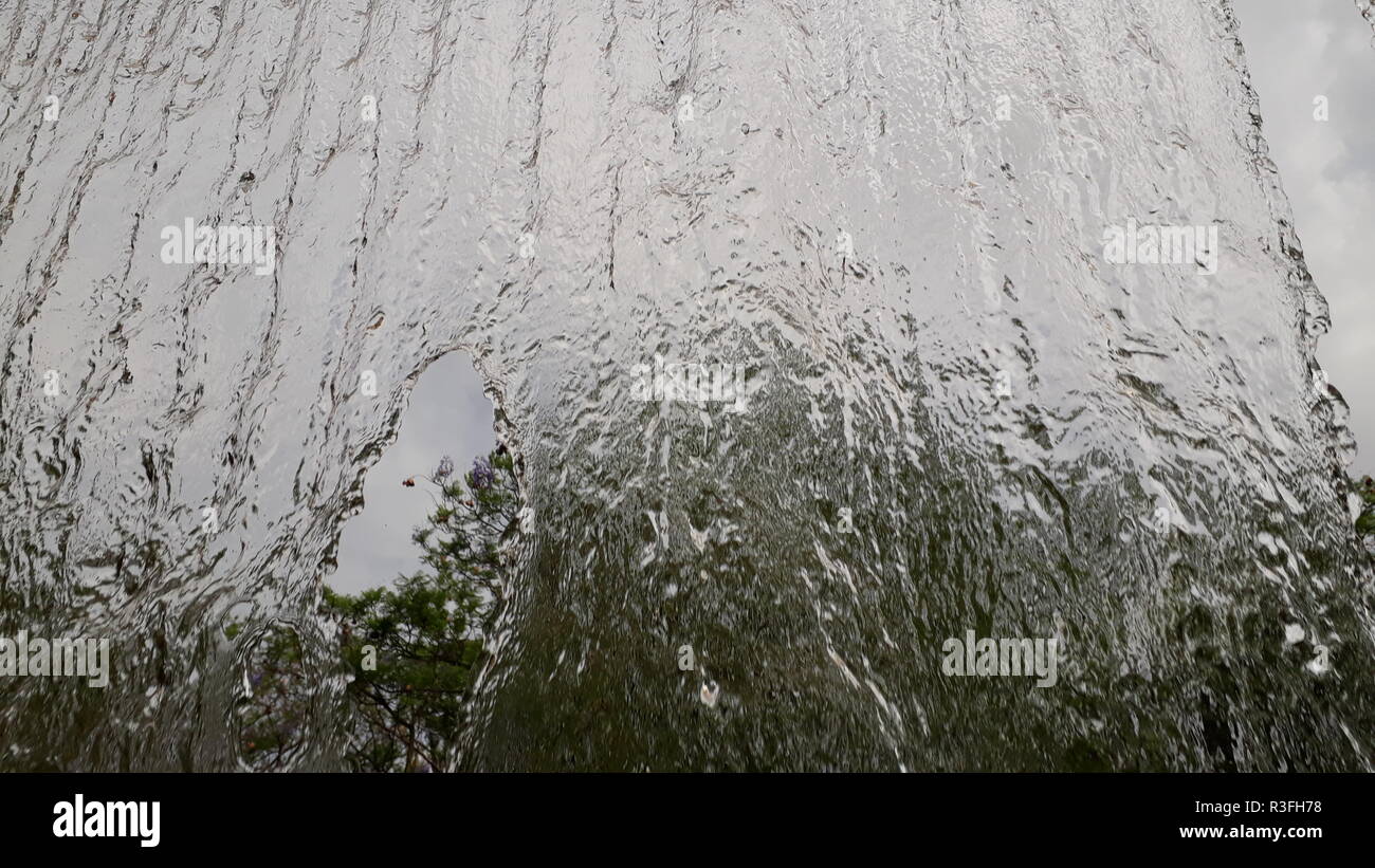 Wide stream of water falling in a semi-translucent park Stock Photo - Alamy