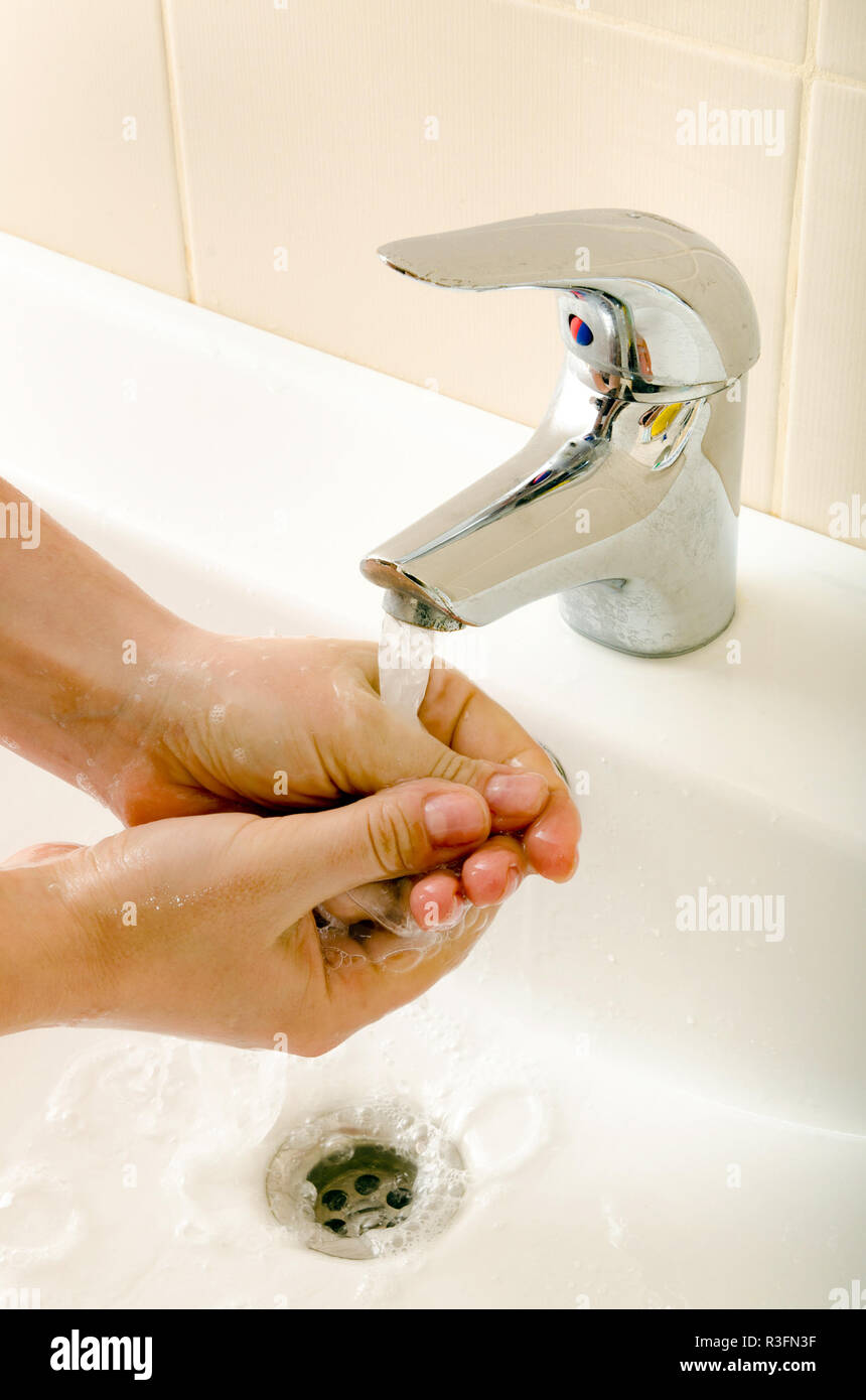 hand washing under the tap closeup Stock Photo - Alamy