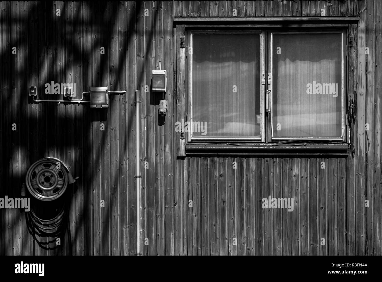 A facade with windows of a small wooden house in black and white, Kil ...