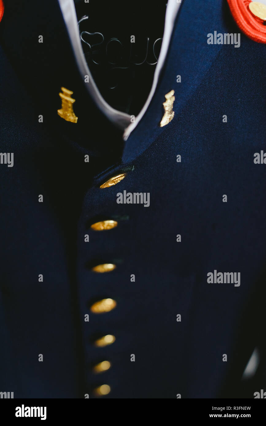 Military dress suit jacket hanging on a hanger Stock Photo - Alamy
