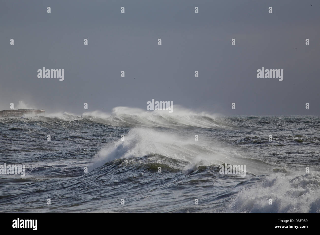 Long windy sea waves approaching the portuguese coast Stock Photo - Alamy