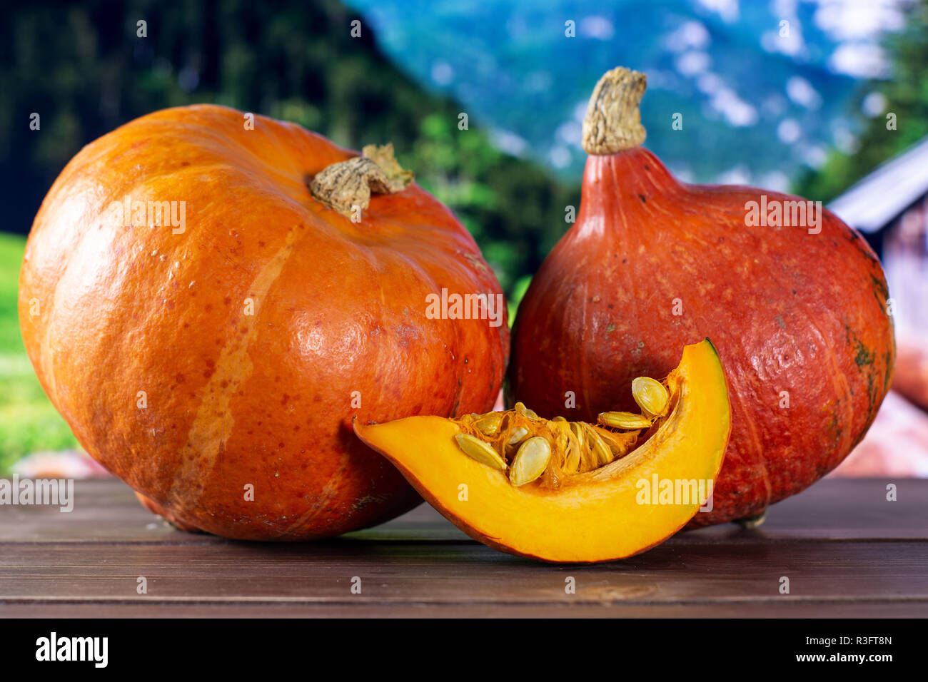 Group of two whole one slice of fresh red kuri pumpkin hokkaido variety ...
